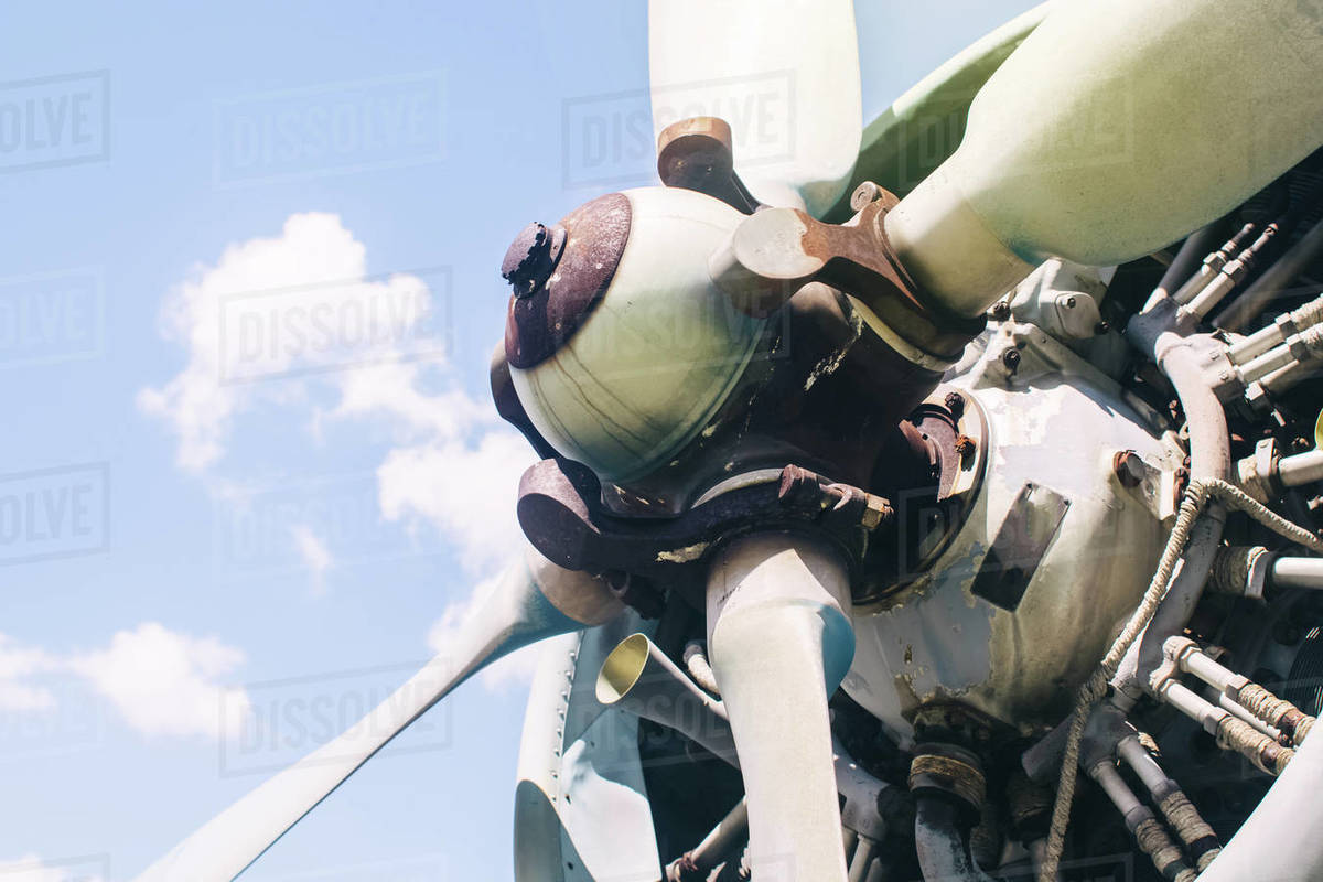 A close-up of an old aircraft engine showing rust and breakage. Visible ...