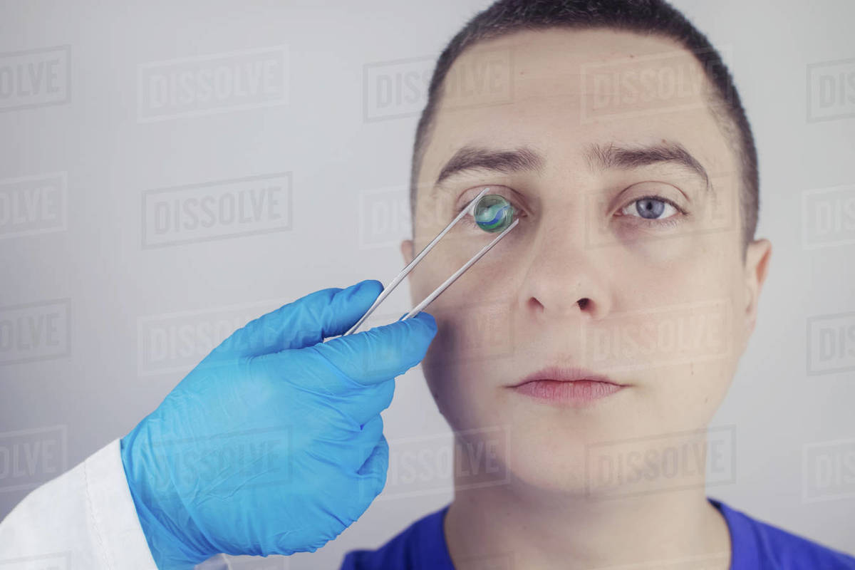 Conceptual shot of an eye crystalline lens replacement. Ophthalmic ...