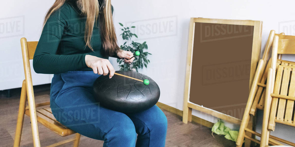 Close-up of a teacher on playing the glucophone. Playing on steel ...