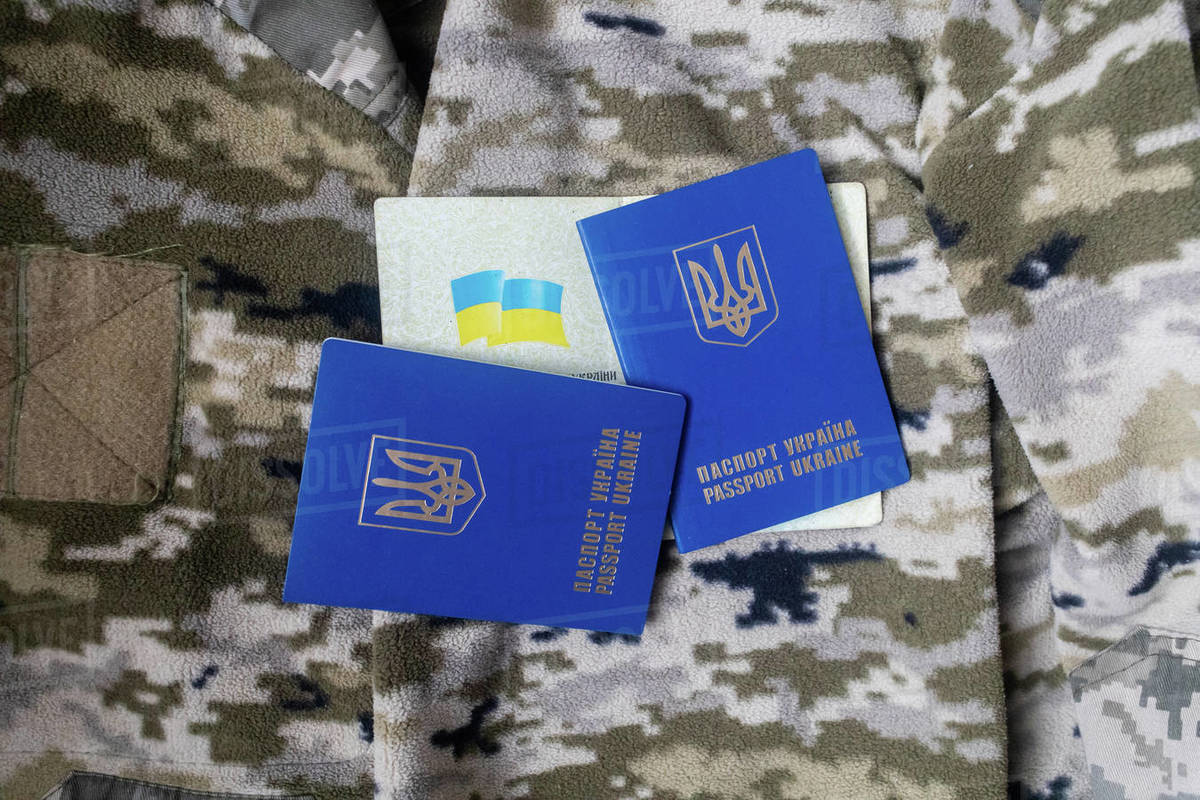 Concept. A Ukrainian soldier in camouflage is holding a Ukrainian ...