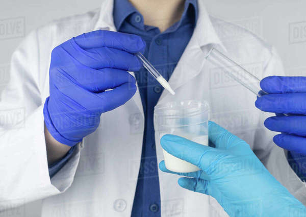 Medical laboratory assistant checks a test tube with sperm. Spermogram ...