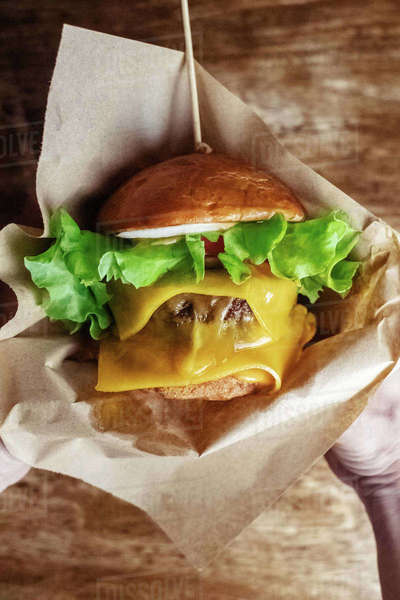 Close-up of a double burger. Adult fast food in a restaurant or cafe ...