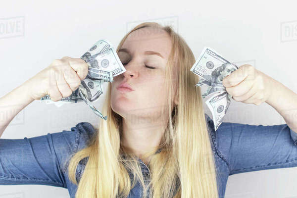 Close-up of a girl sniffing money. Madness and greed from currency. The ...