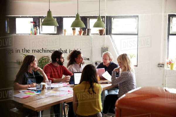 Group of designers meeting around table in modern office - Royalty-free ...