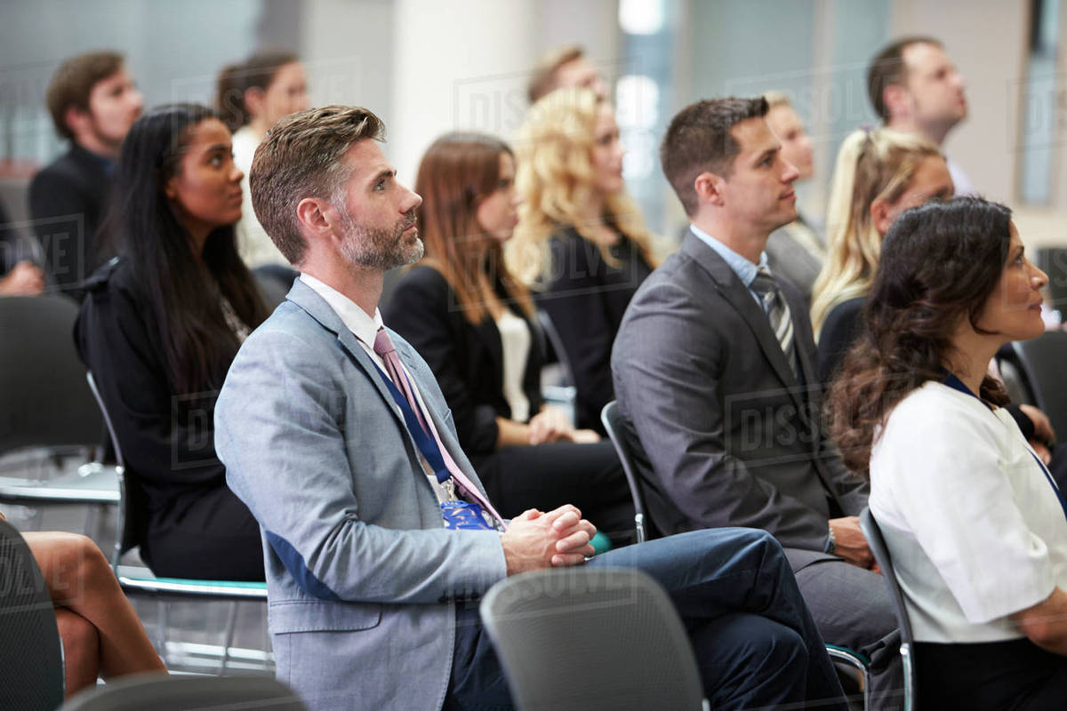 Audience listening to speaker at conference presentation - Royalty-free ...