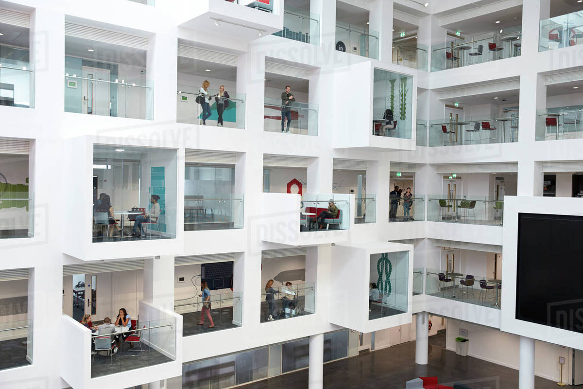 Wide view of students in study cubicles in modern university - Stock ...