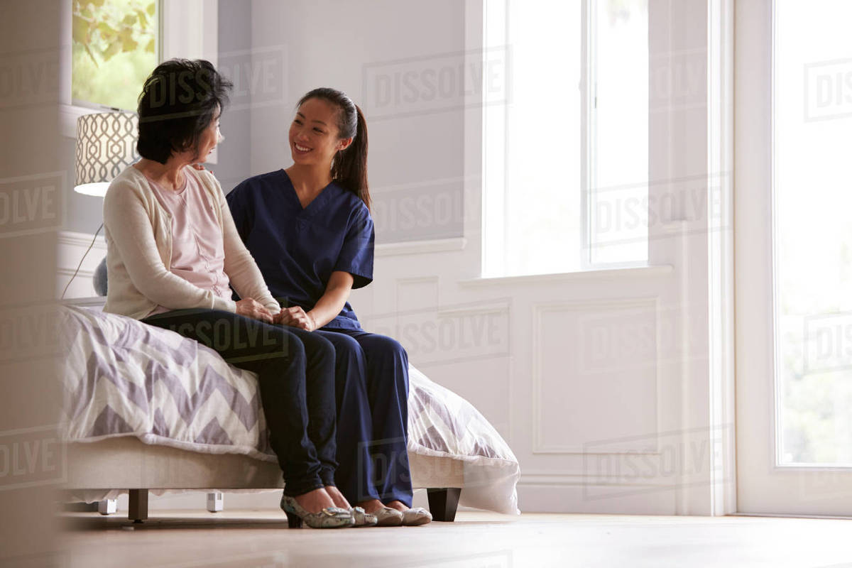 Nurse Making Home Visit To Senior Woman - Stock Photo - Dissolve