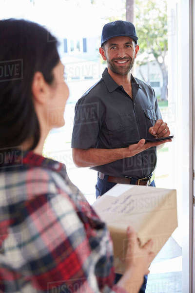 Courier Collecting Package From Woman At Home - Royalty-free Stock ...