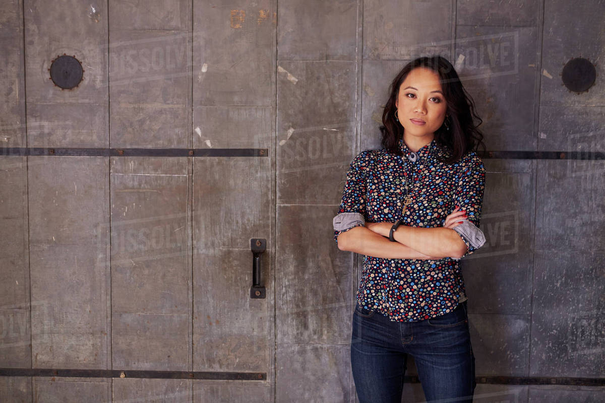 Portrait of female designer standing in modern office - Royalty-free ...