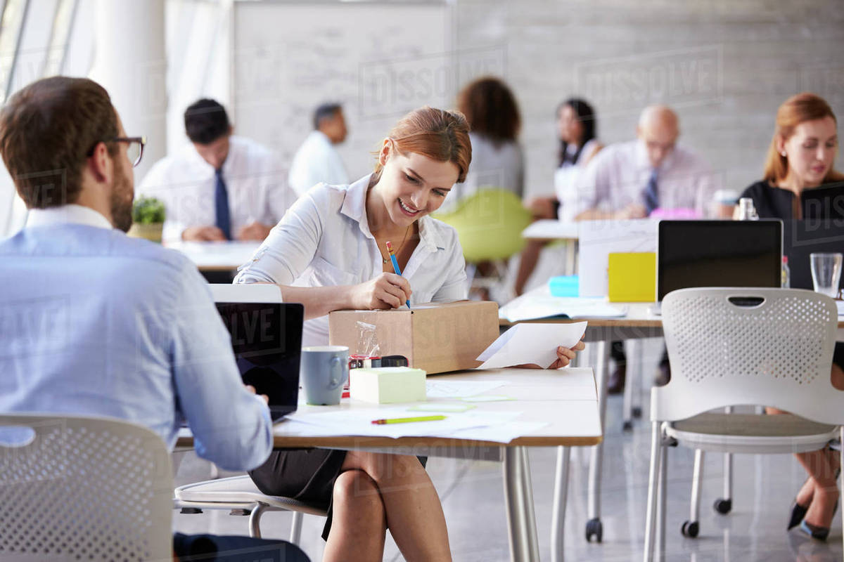 Businesswoman in office addressing package for shipping - Royalty-free ...