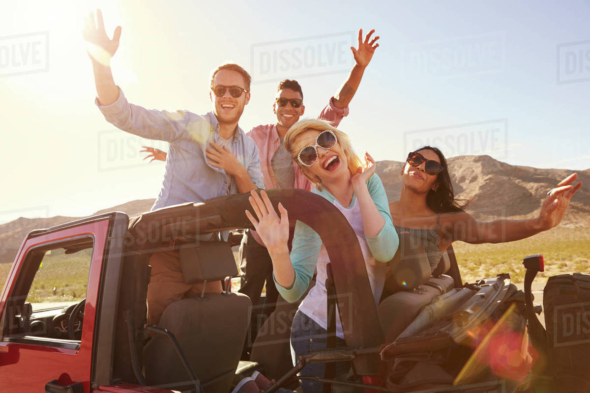 Friends on road trip standing in convertible car - Royalty-free Stock ...