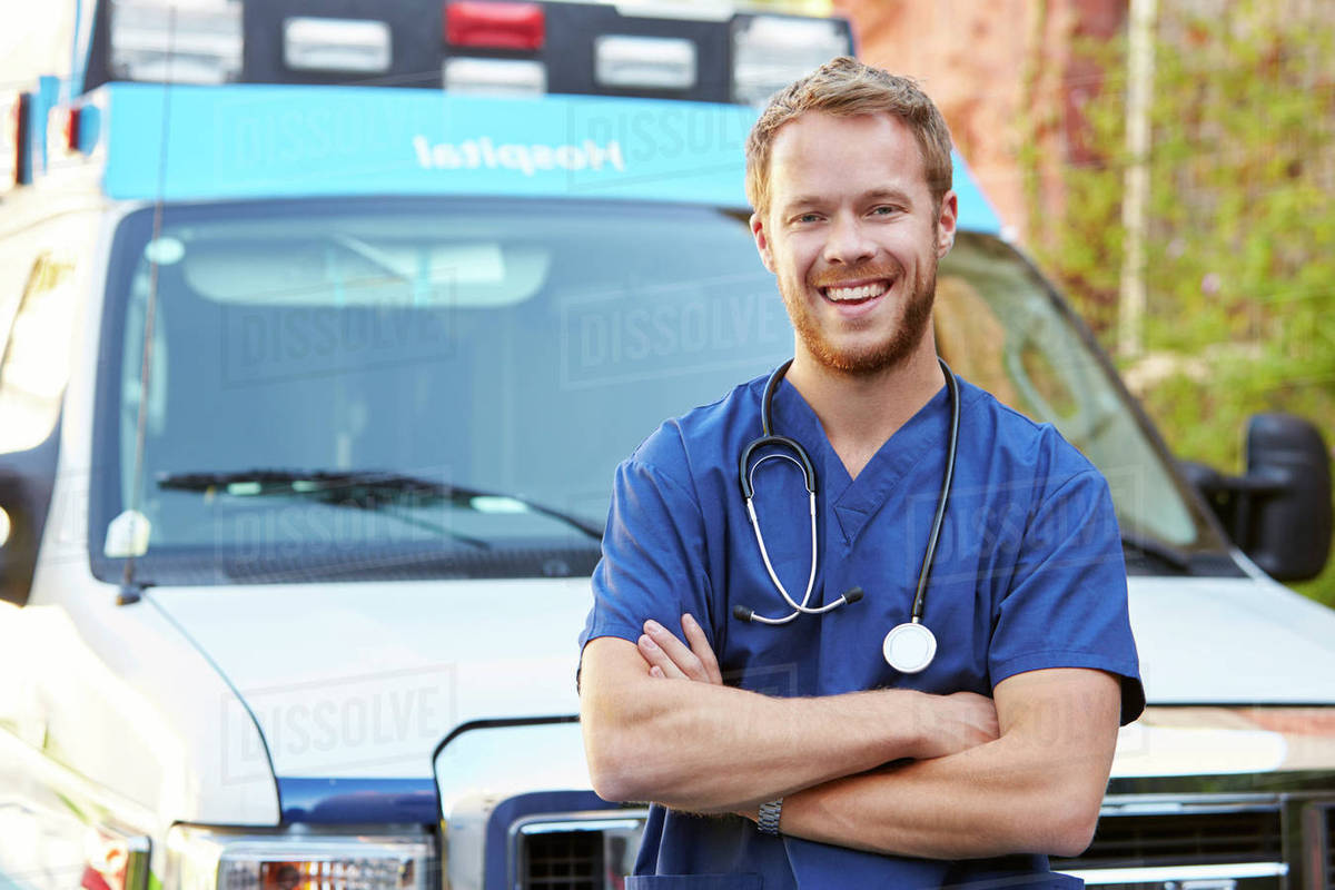 Portrait of male doctor standing in front of ambulance - Royalty-free ...