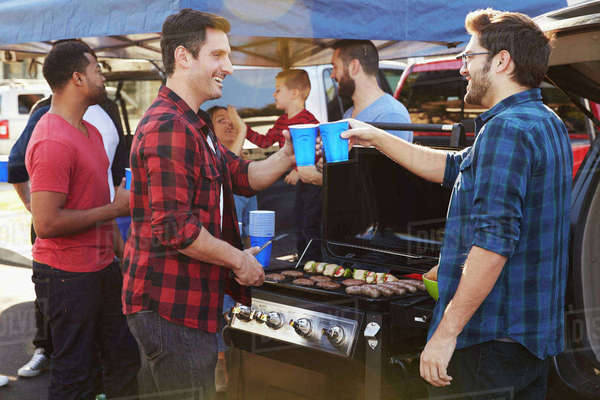 Group Of Sports Fans Tailgating In Stadium Car Park - Royalty-free ...