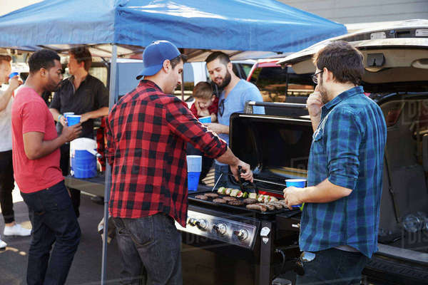 Group Of Sports Fans Tailgating In Stadium Car Park - Royalty-free ...