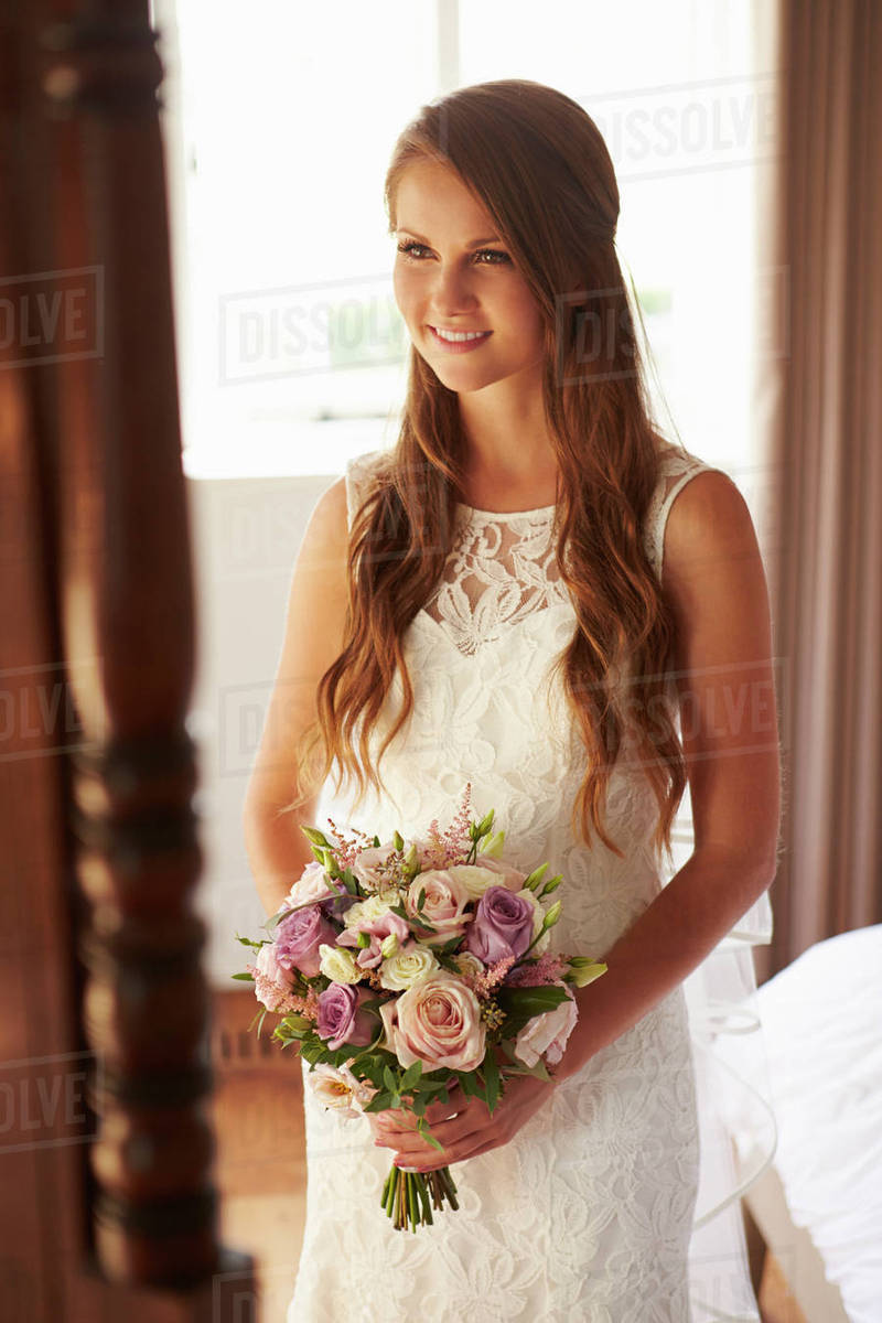 Beautiful Bride In Bedroom Looking at Mirror - Stock Photo - Dissolve