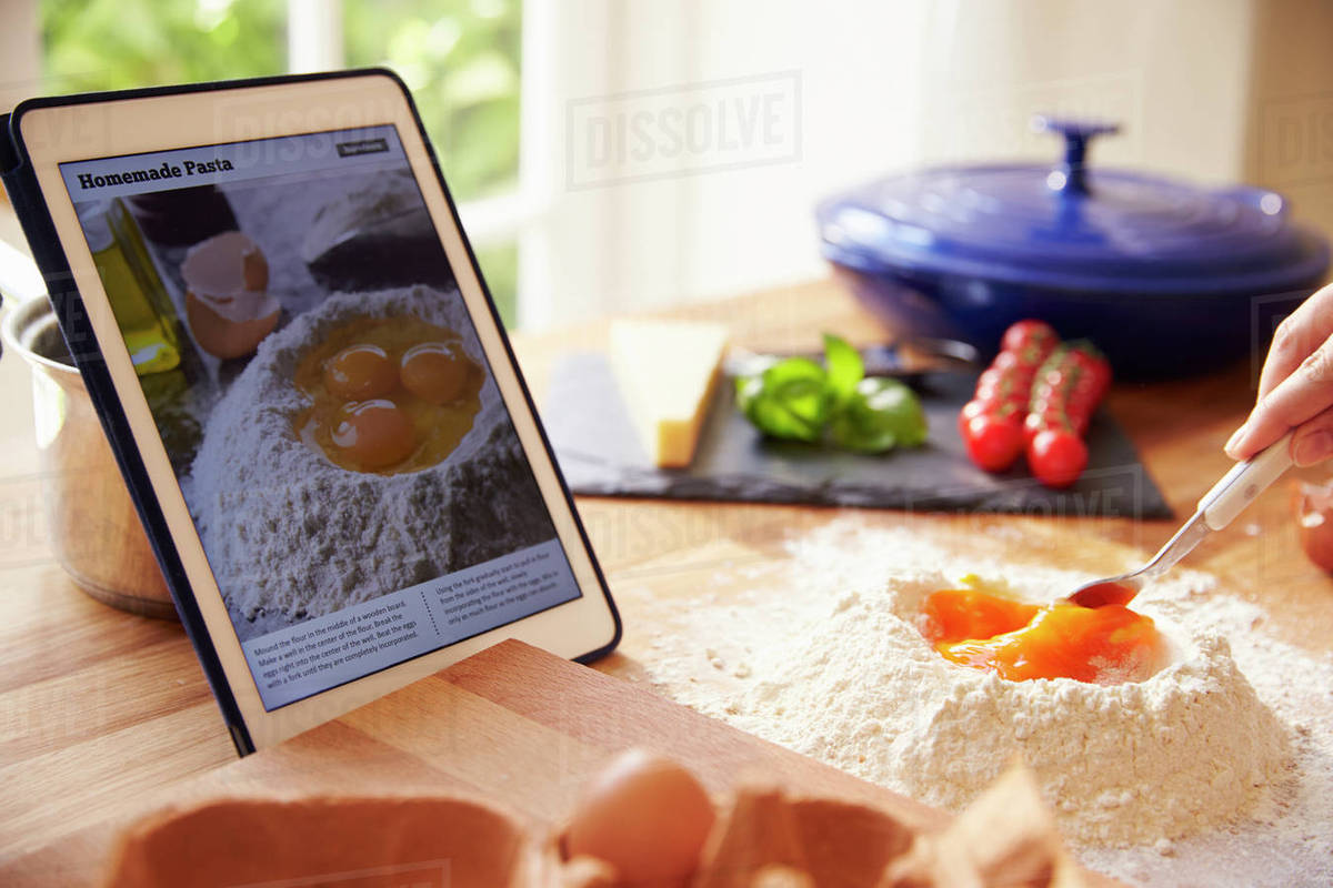 Person following pasta recipe using app on digital tablet - Stock Photo ...
