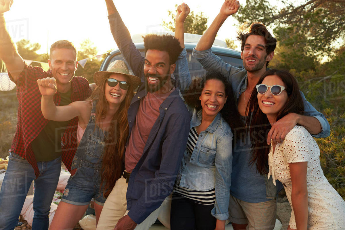 Friends on a road trip holiday look to camera, full length - Royalty ...