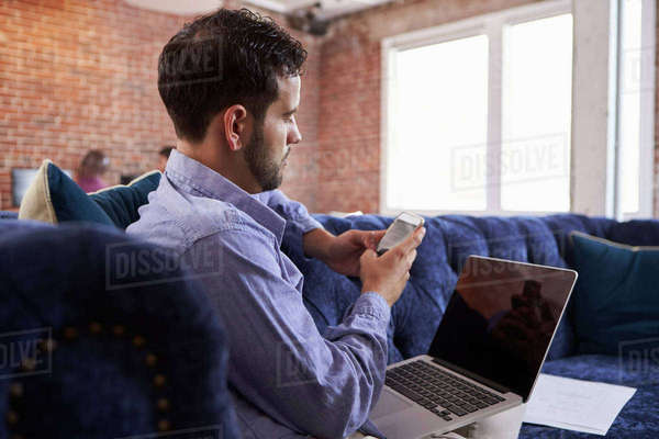 Businessman working on sofa in modern creative office - Royalty-free ...