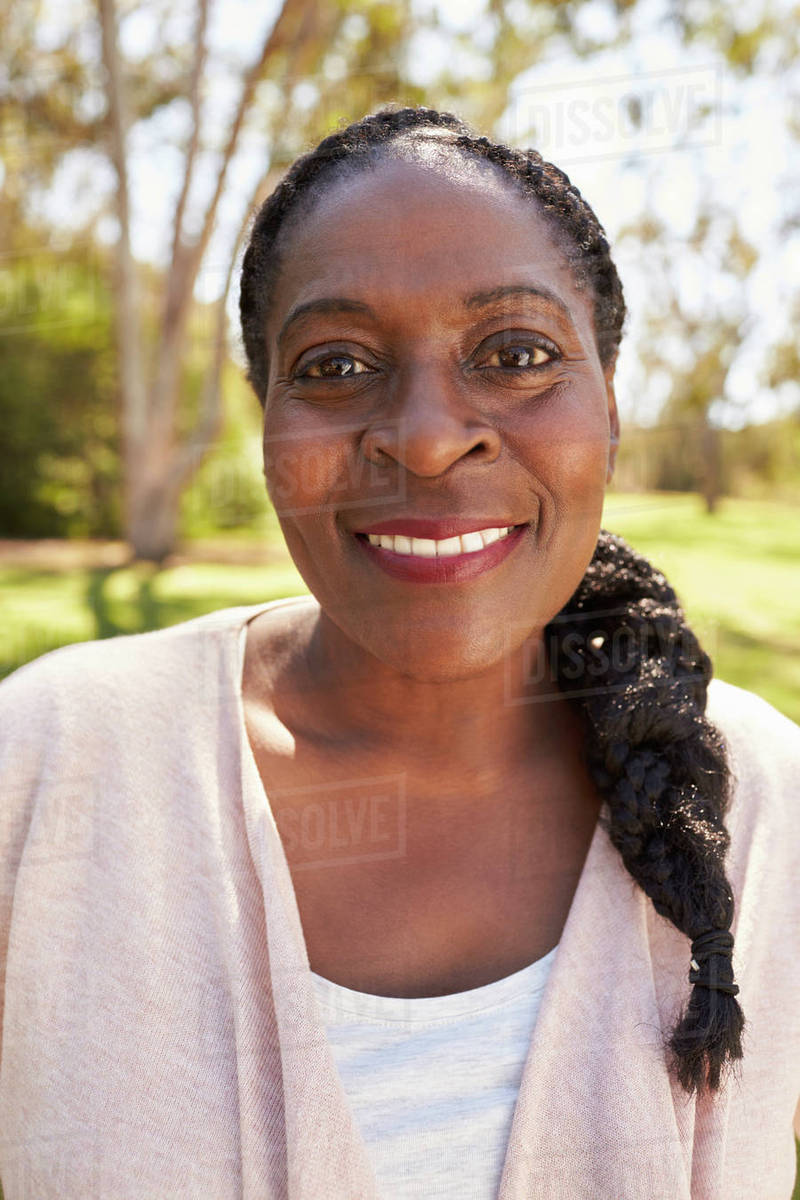 Head and shoulders portrait of mature woman in park - Royalty-free ...