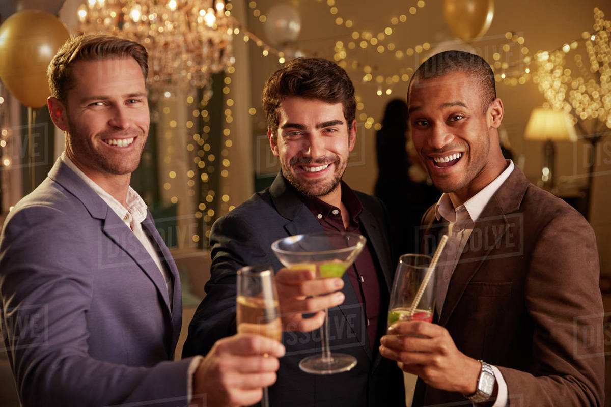 Male friends celebrating at party make toast to camera - Royalty-free ...