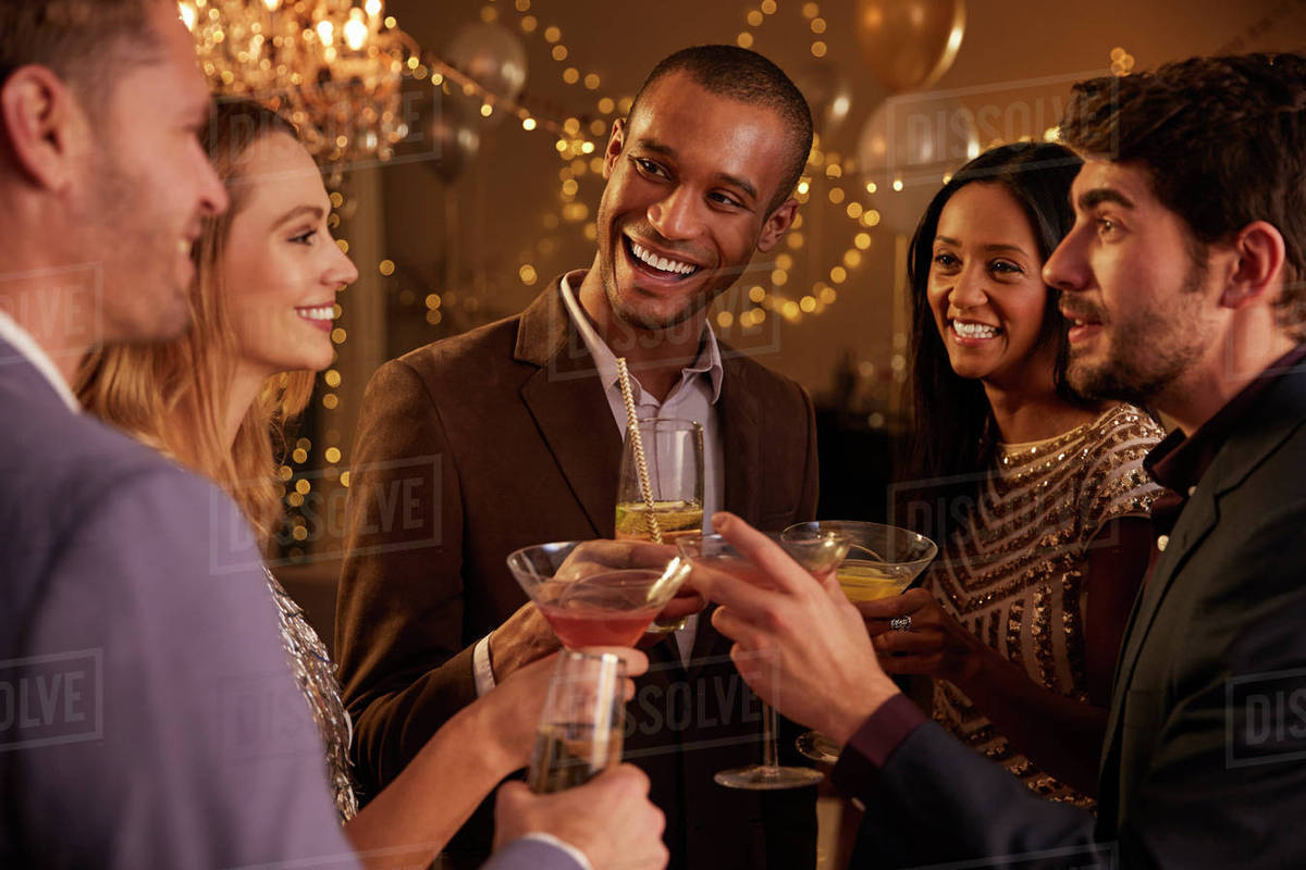 Group of friends with drinks enjoying cocktail party - Royalty-free ...