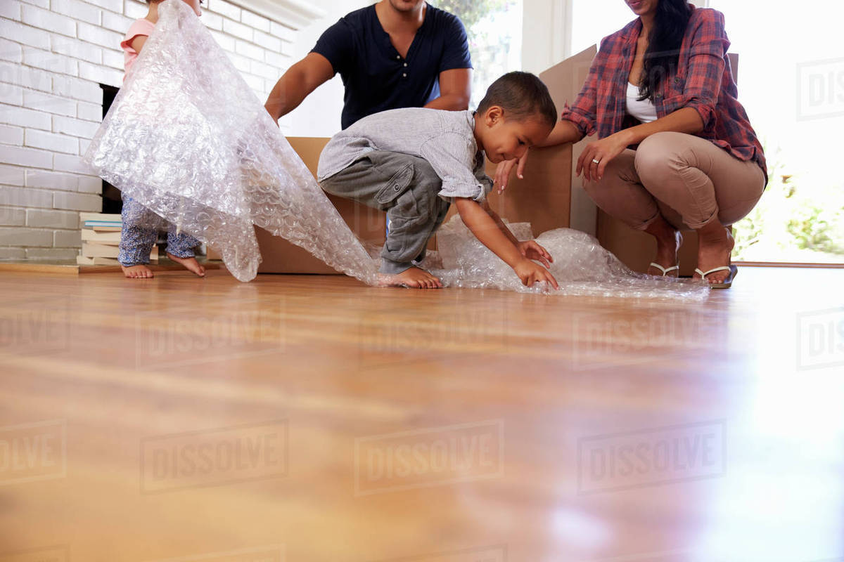 Family unpacking boxes in new home on moving day - Royalty-free Stock ...