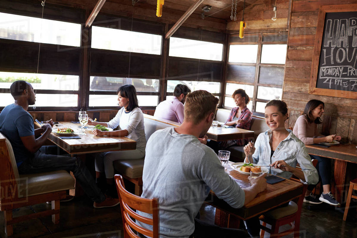 Young couples eating lunch relax in a restaurant - Royalty-free Stock ...