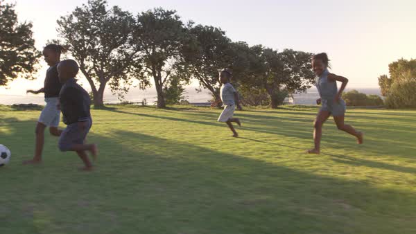 Elementary school kids playing football in a field - 4K Royalty-free ...