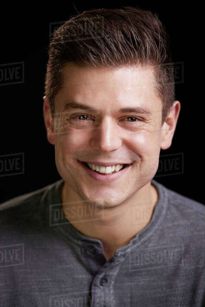 Smiling young white man looking to camera, vertical portrait - Royalty ...