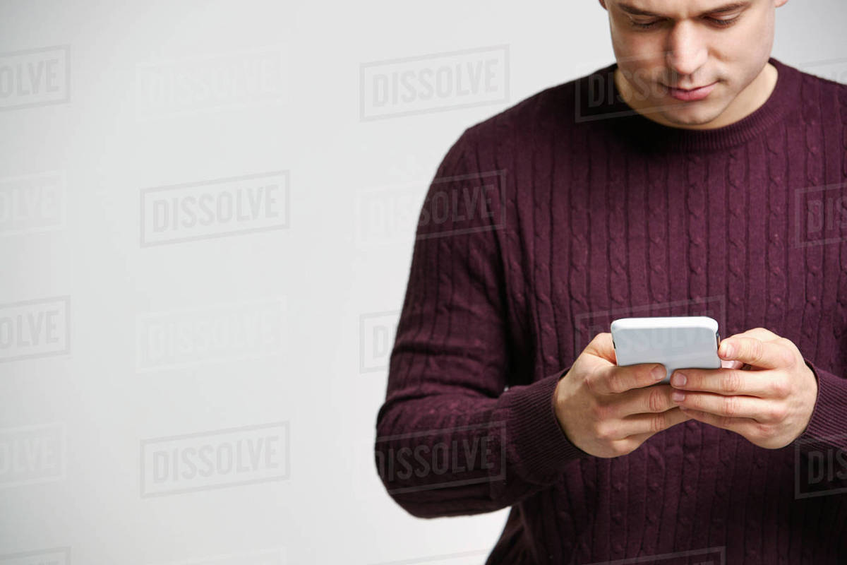 Close up portrait of a young white man using a smartphone - Royalty ...