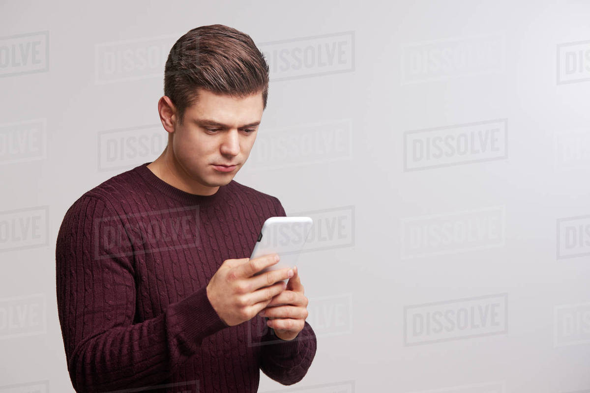Portrait of a young white man using a smartphone - Royalty-free Stock ...