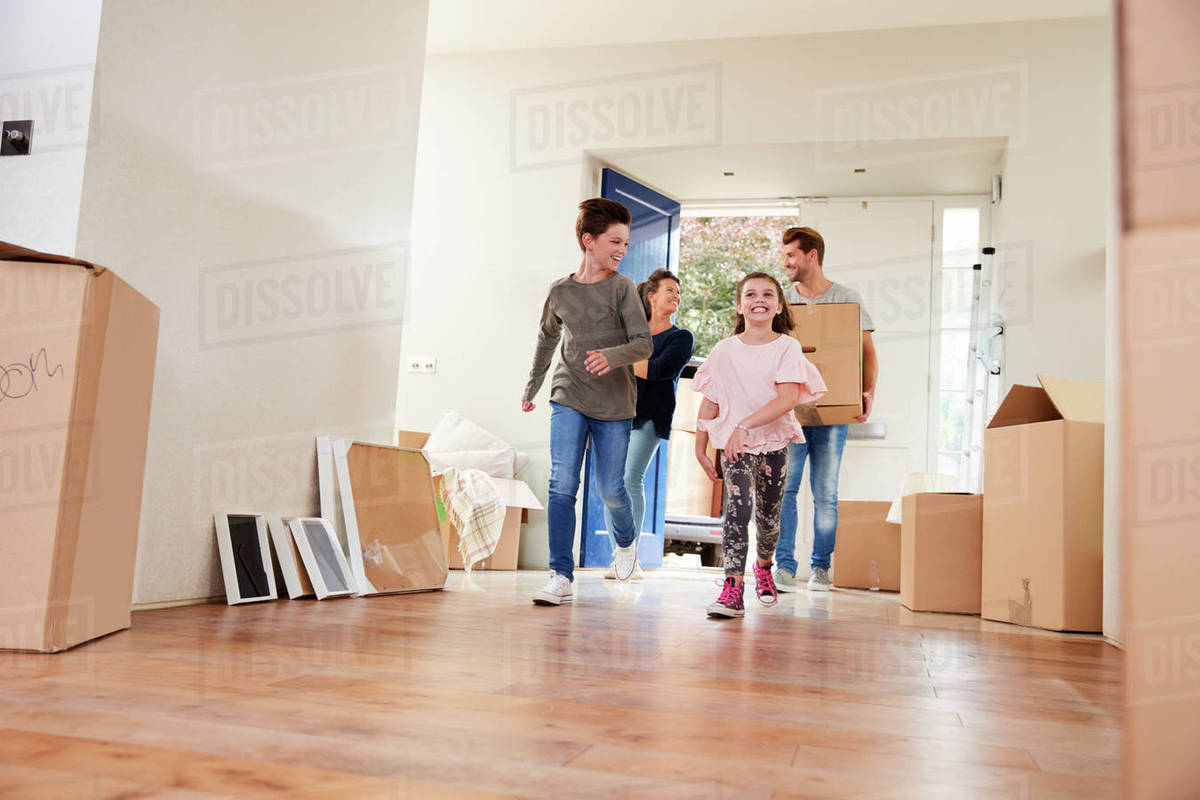 Family Carrying Boxes Into New Home On Moving Day - Royalty-free Stock ...