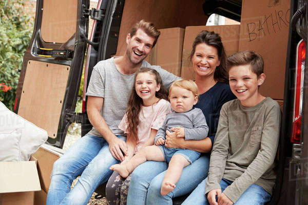 Family Sitting In Back Of Removal Truck On Moving Day - Stock Photo ...