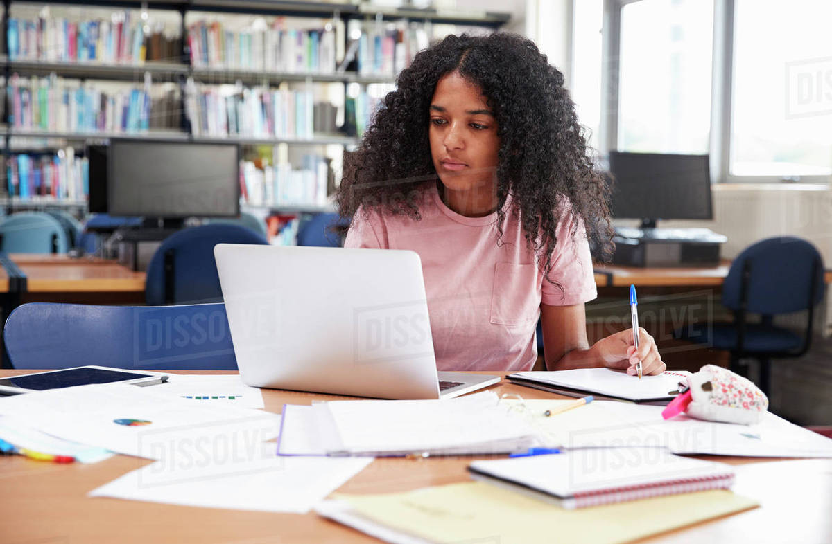 Female Student Working At Laptop In College Library - Royalty-free ...