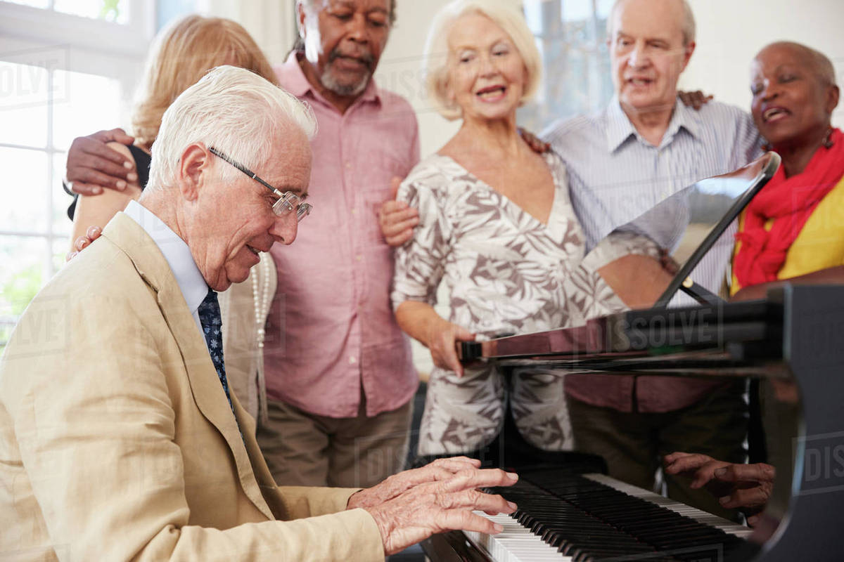 Group Of Seniors Standing By Piano And Singing Together - Royalty-free ...