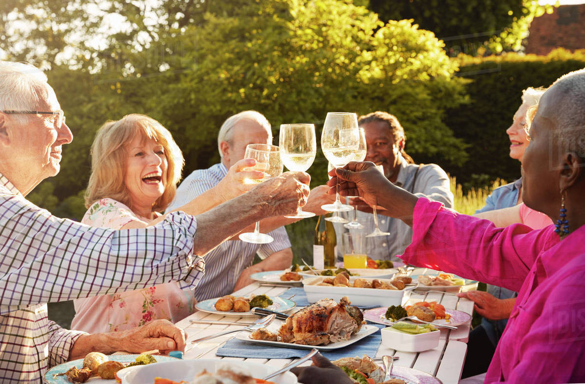 Group Of Senior Friends Enjoying Outdoor Dinner Party At Home - Royalty ...