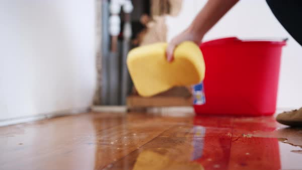 Close Up Of Woman At Home Mopping Up Water From Leaking Pipe - 4K ...