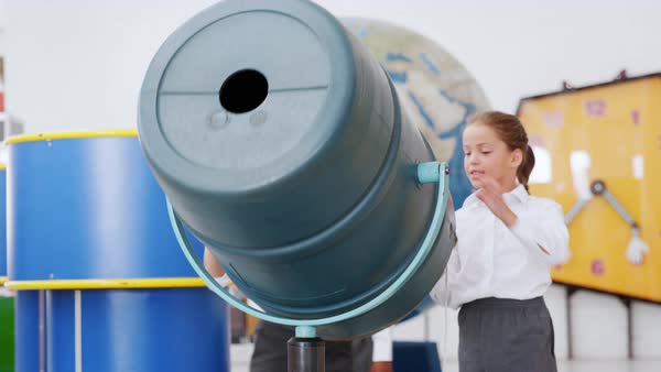 Kids playing with an air cannon at a science activity centre - Stock ...