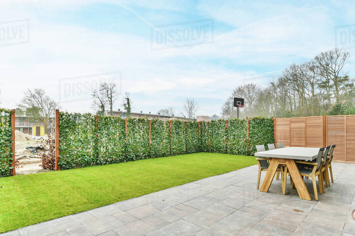 Beautiful backyard terrace full of furniture and decorative plants ...