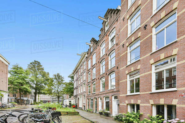 Facade of typical low rise brick building with large windows and ...