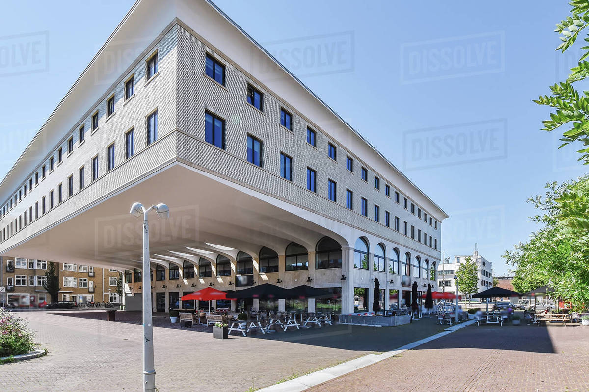 Exterior of contemporary building of shopping mall under blue sky in ...