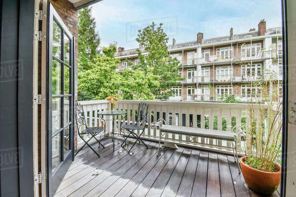 Sleek balcony design with metal table and chair - Royalty-free Stock ...