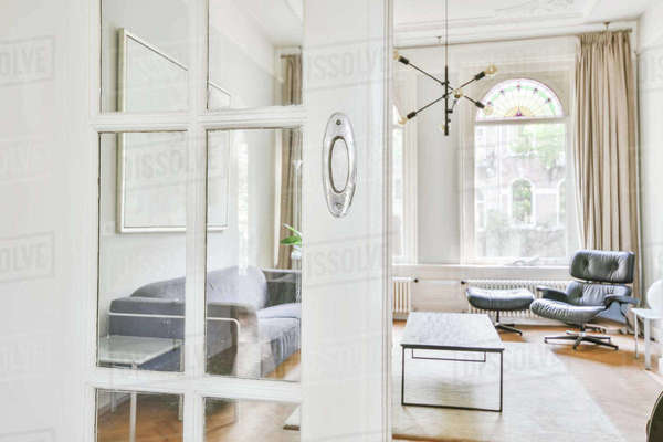 Semi-open door leading to a cozy living room - Royalty-free Stock Photo ...