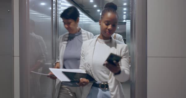 Elevator exit, door and business people busy in an office for corporate ...