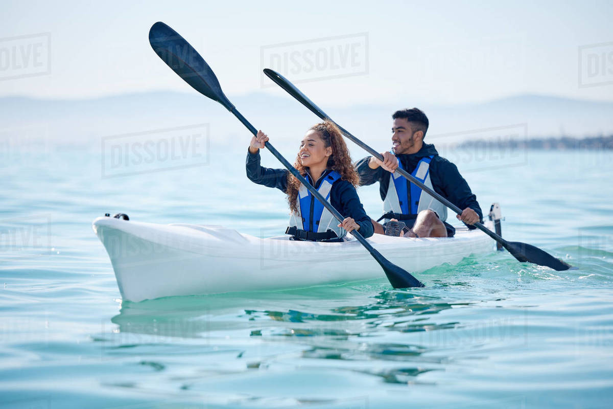 Kayak, couple and rowing boat on lake, ocean or river for water sports ...