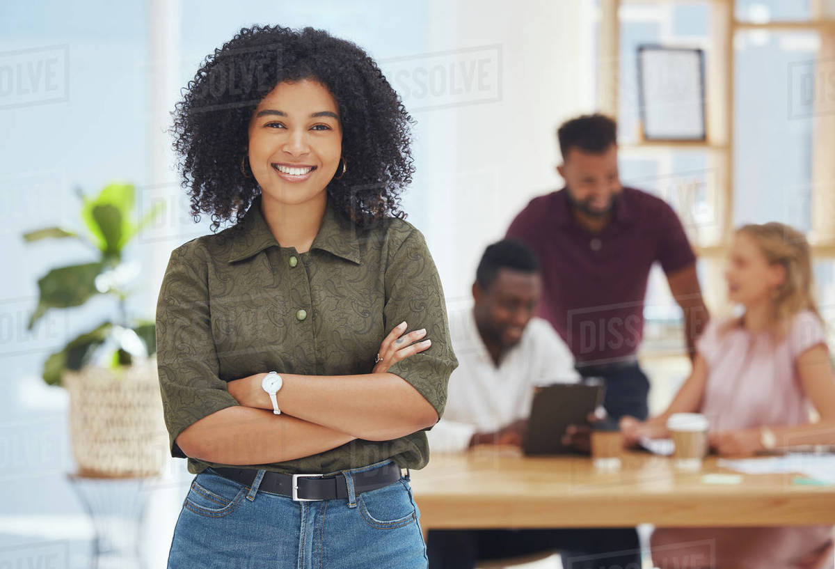 Black woman, leader and crossed arms in office, workplace and happy group project, startup ...