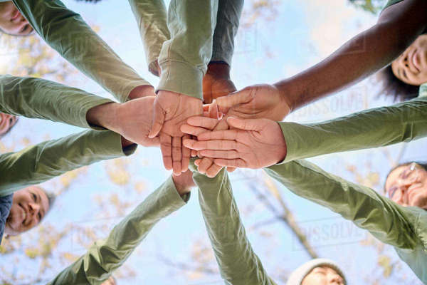 Teamwork, collaboration and low angle of people with hands together for ...