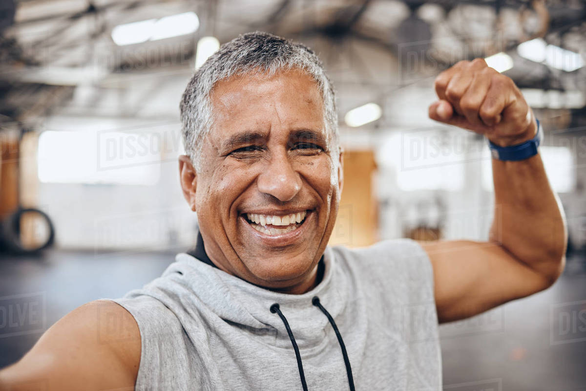 Muscle, exercise and selfie portrait of old man in gym show biceps for motivation, wellness and ...