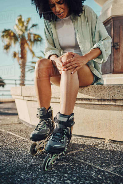 Knee pain, roller skater injury and woman in city after accident or ...