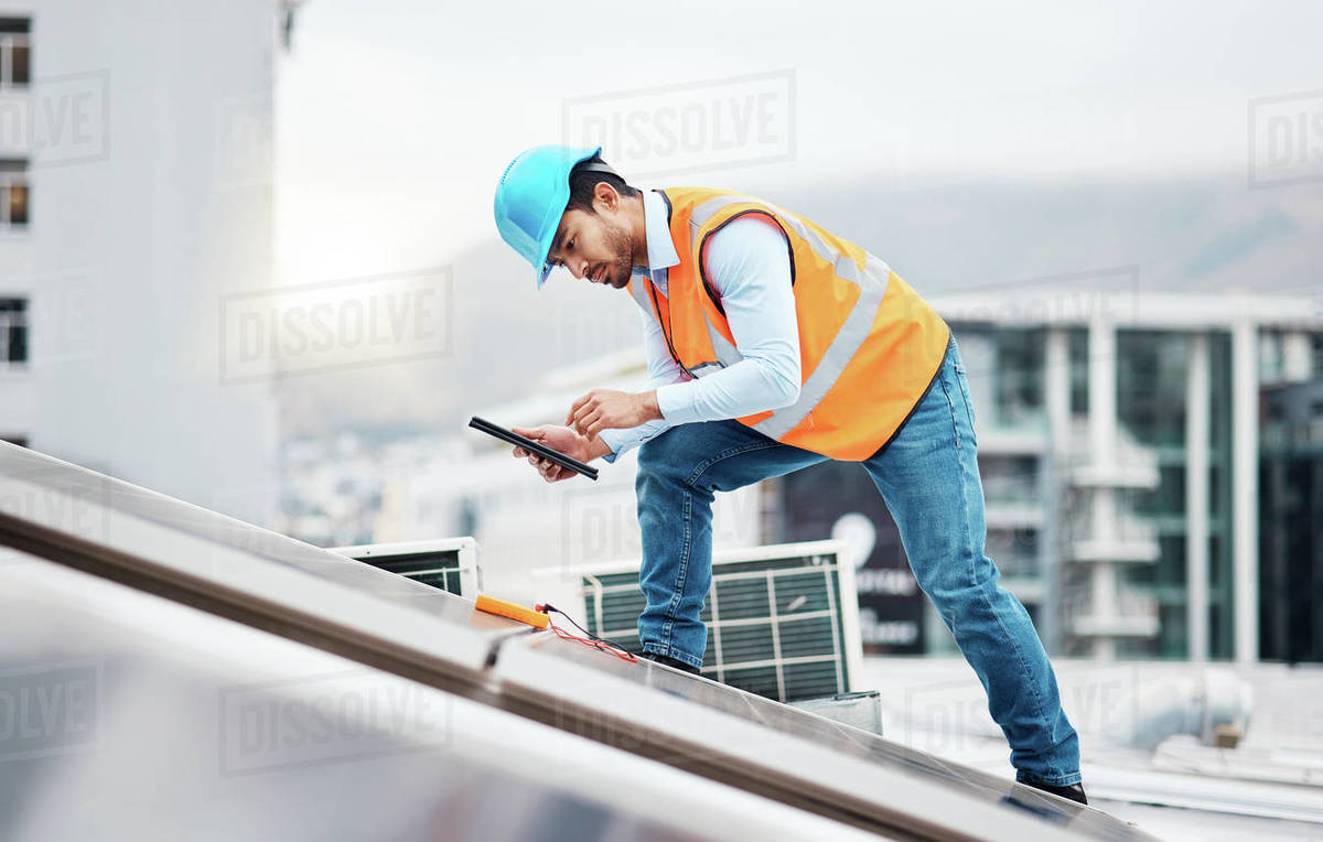 Solar panel, tablet and engineering with man on roof top for renewable ...
